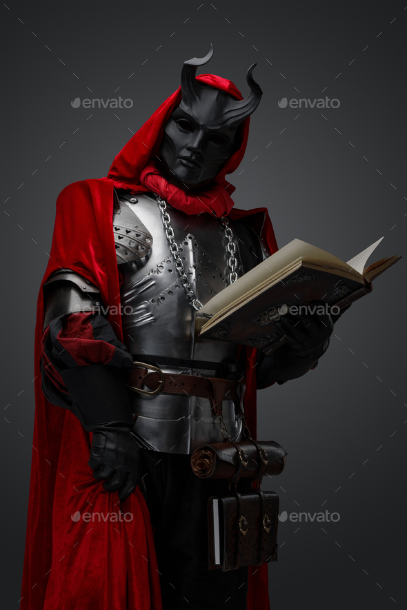 Mystic priest of dark cult with red robe and book Stock Photo by fxquadro