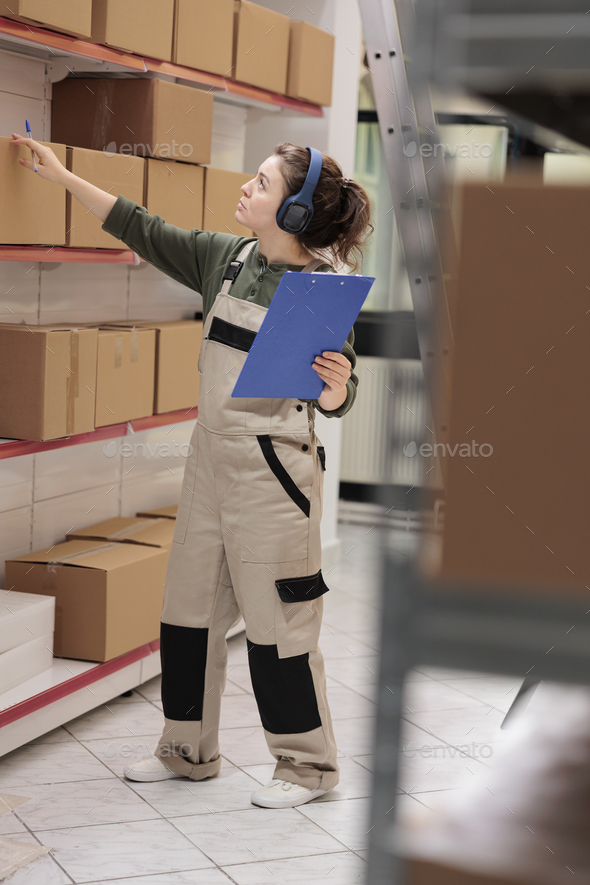 Employee checking carton boxes looking at shipping details Stock Photo ...