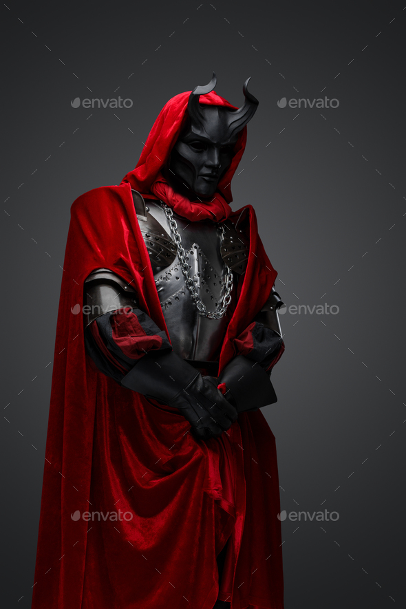Spooky member of cult with black mask and red cloak Stock Photo by fxquadro