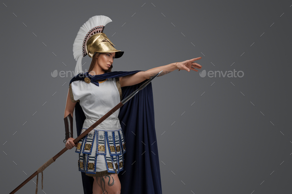 Female greek warrior with spear and golden plumed helmet Stock Photo by ...
