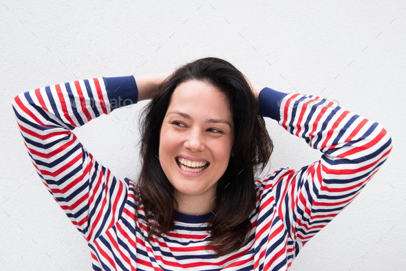 Close up cheerful young woman laughing with hands behind head Stock ...