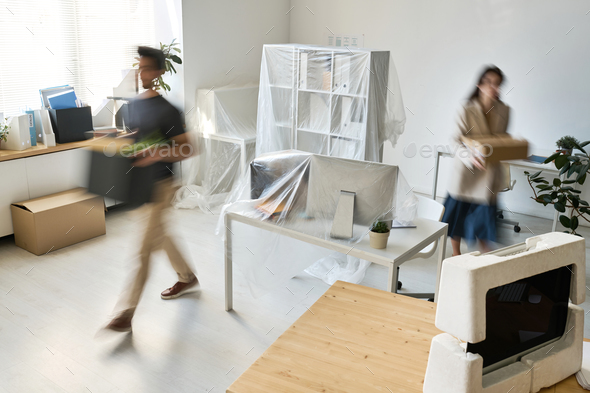 Business people carrying things during the move Stock Photo by Media_photos