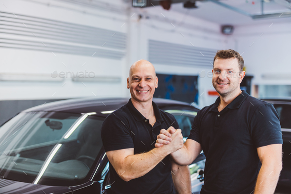 Car mechanics team in car detailing workshop, teamwork partners Stock ...