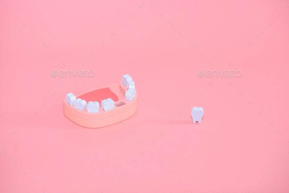 Teeth loss concept. Wooden jaw model with missing or extracted tooth ...
