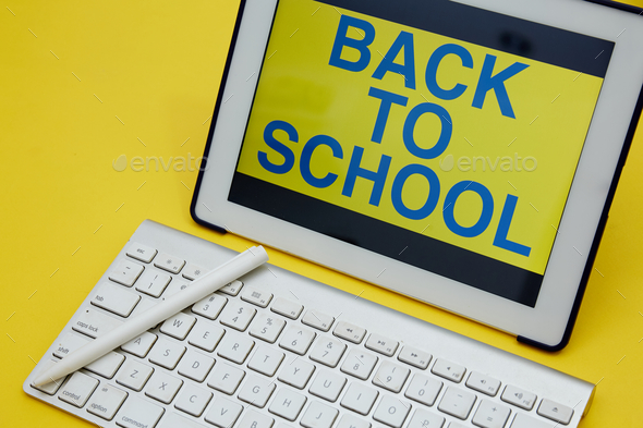 Laptop with the writing "back to school" on the screen, a pen and a ...