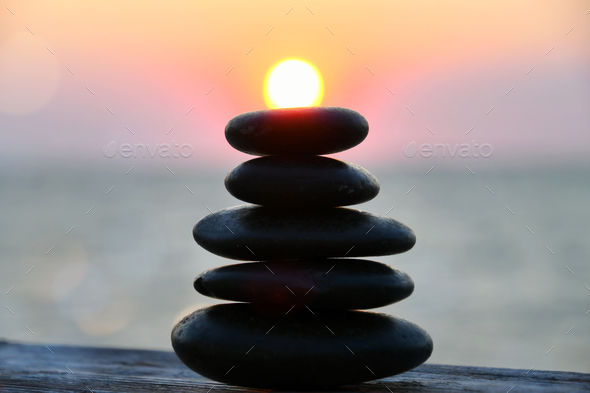 Relaxation Zen concept - cairn, stacked stones outside, blurred sunset ...