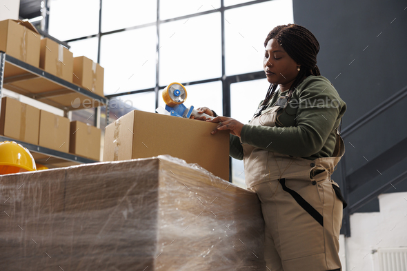 Employee using adhesive tape to pack customers orders Stock Photo by DC ...