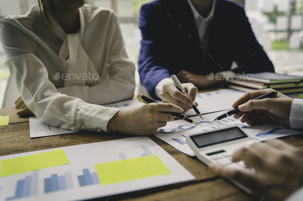 Financial teamwork with Marketing and Accounting, using calculator to ...