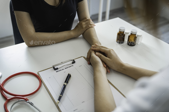 Close up hands Woman doctor holding hands patient encourage cheer up a ...