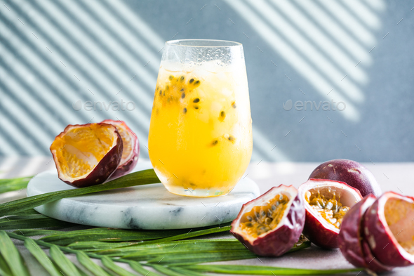 Glass of Iced passion fruit soda with lemon and passion fruit half ...