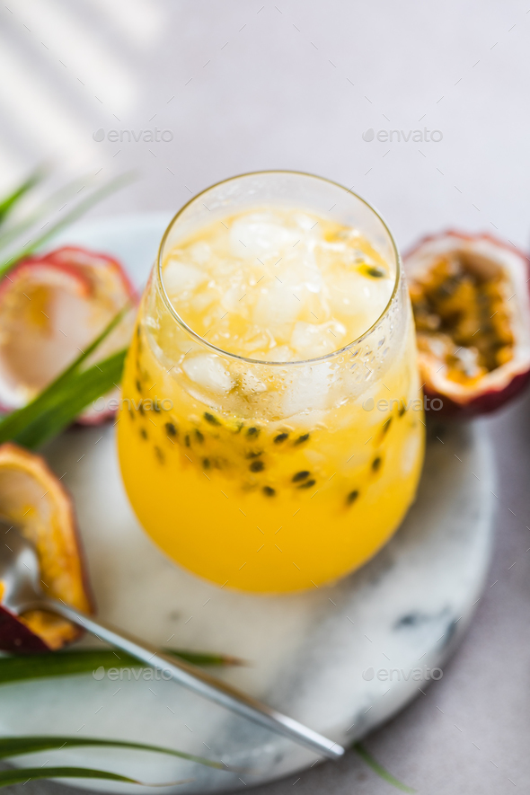Glass of Iced passion fruit soda with lemon and passion fruit half ...