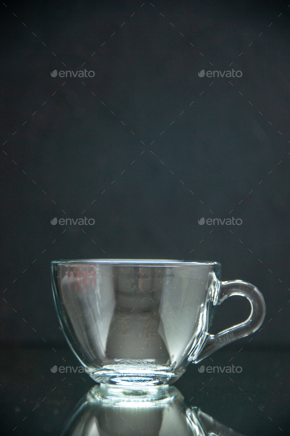 Front view of empty glass cup on dark wave background with free space ...