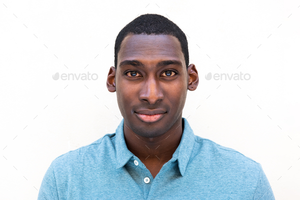 Close up handsome young black man against isolated white background Stock Photo by mimagephotography
