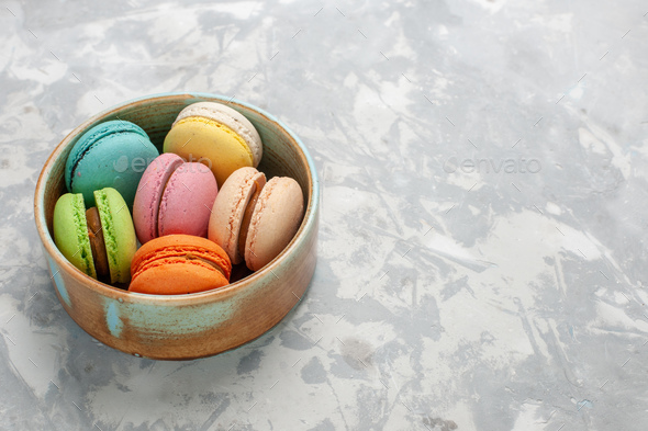 front view colored french macarons delicious little cakes on the light ...