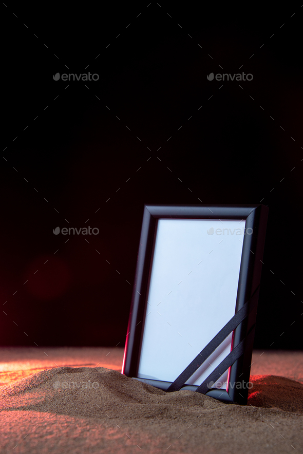 front view of empty picture frame on dark background death funeral ...