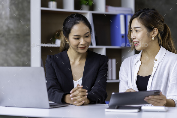 The collaborative process of young Asian business people team sitting ...