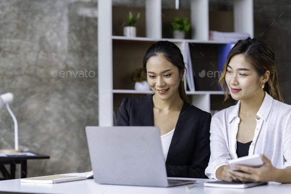 The collaborative process of young Asian business people team sitting ...
