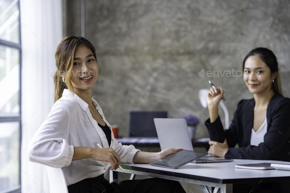The collaborative process of young Asian business people team sitting ...