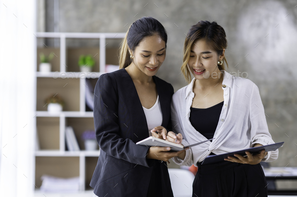 The collaborative process of young Asian business people team standing ...