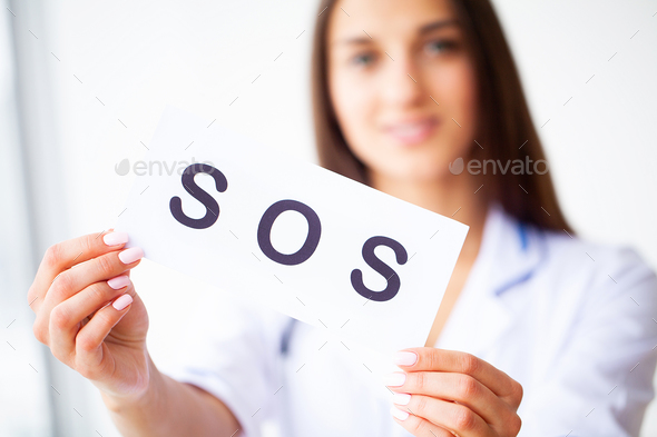 Health Care. Doctor Holding a Card With Symbol SOS, Medical Concept ...