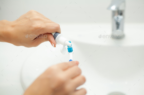 Close up hands woman use toothbrush in light bathroom Stock Photo by ...
