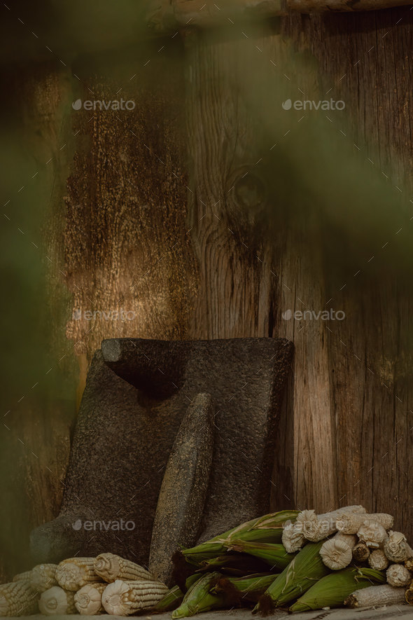 In the rustic kitchen, the wooden metate grinds corn, creating food and ...