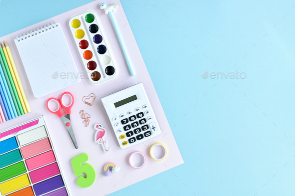 Background of school supplies in pastel colors on a light blue ...