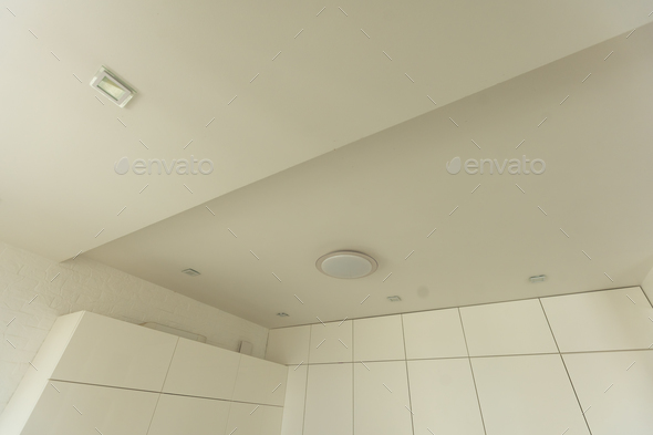 Clean gypsum board ceiling in construction site. Under construction a ...
