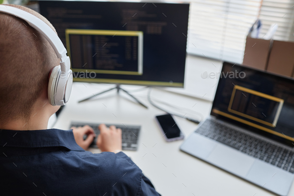 Back view of bald young woman wearing headphones andwriting code Stock ...