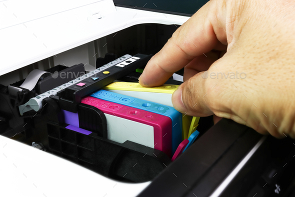 Technicians are install setup the ink cartridge of a inkjet printer ...