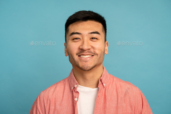 Smiling asian man in a studio shot. Stock Photo by TheAtticoStudioPhoto