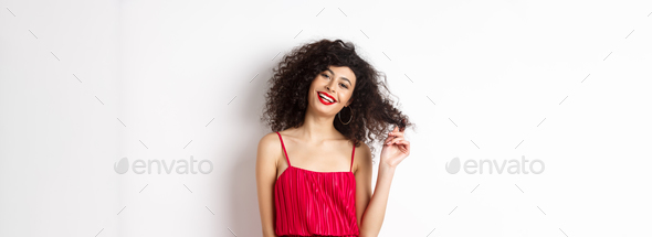 Beautiful woman with curly hair, wearing red dress and lipstick ...