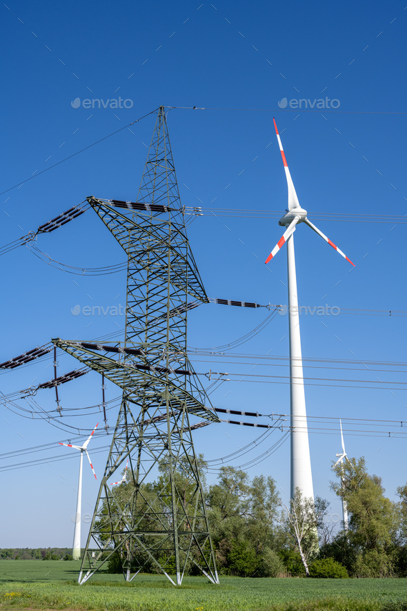 Wind turbine and an electricity pylon Stock Photo by elxeneize | PhotoDune