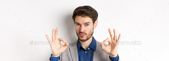 Not bad. Impressed caucasian businessman nod in approval, showing okay ...