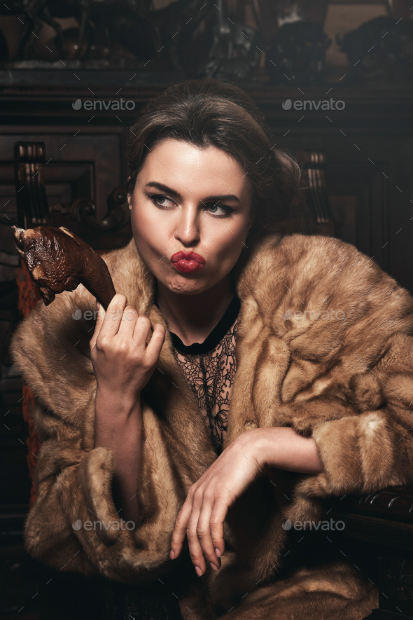 Provocative image of woman wearing fur coat and eating smoked chicken ...