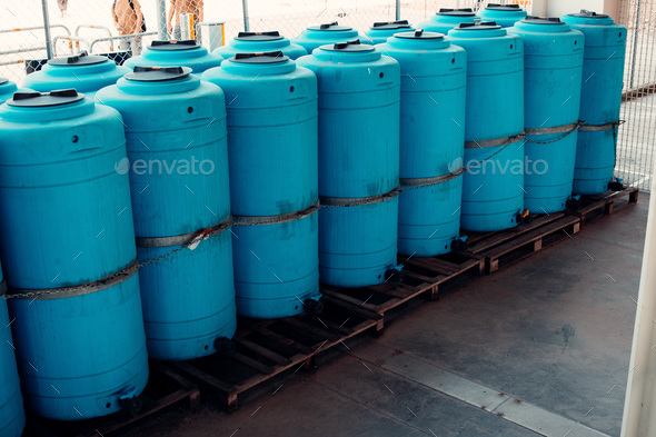 Large, blue plastic containers for industrial storage of water and ...