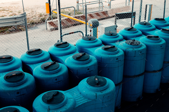 Large, blue plastic containers for industrial storage of water and ...