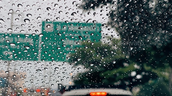 Rain on the windshield while traffic jams. Toned with color filter and ...