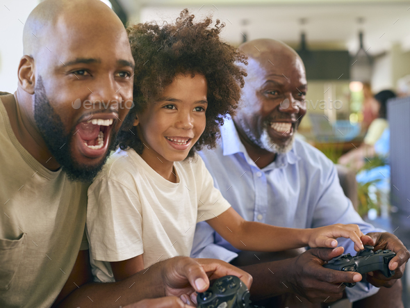 Multi-Generation Male Family Having Fun Playing Computer Game Sitting ...