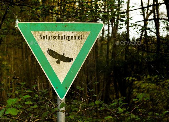 Outdoor triangle sign indicating the entrance to a nature reserve in a ...