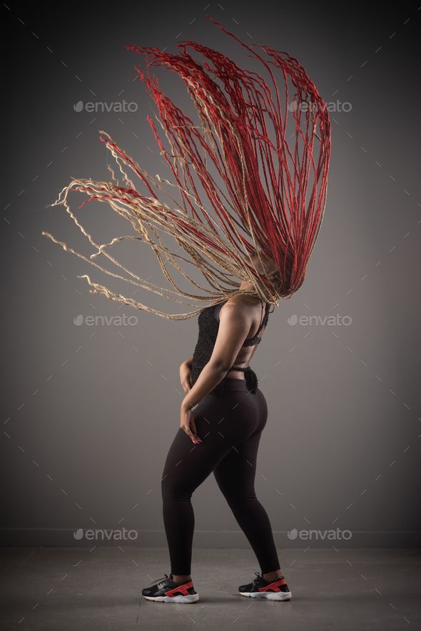 African American female in a black outfit and red braids joyfully ...
