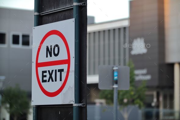No-exit sign taped to a metal pole Stock Photo by wirestock | PhotoDune