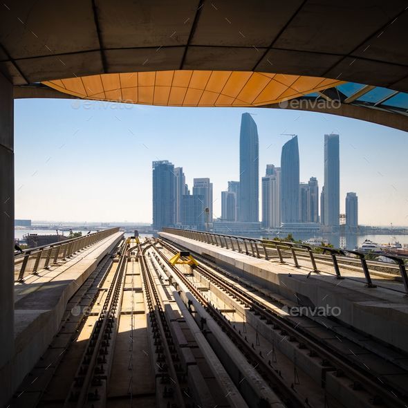 View of a metropolitan area featuring a railway bridge with skyscrapers ...