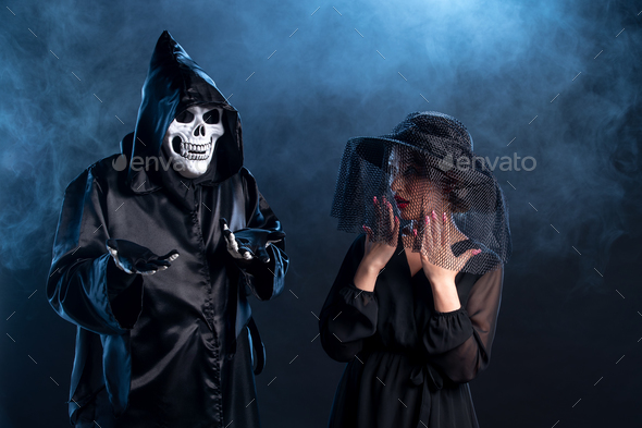 young woman dressed in all black on the dark background grim reaper ...