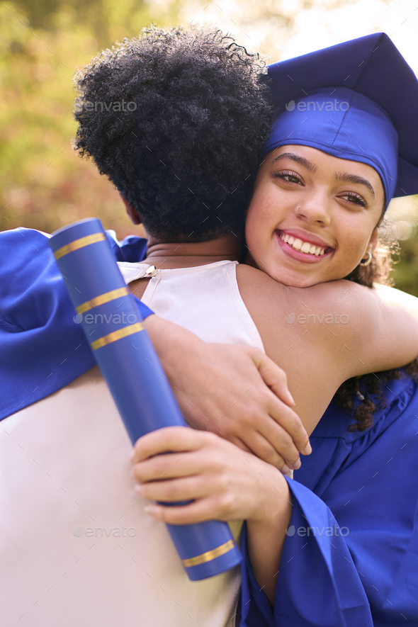 Proud Mother Celebrating And Hugging Teenage Daughter Wearing ...