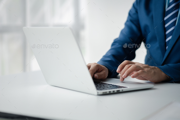 Person typing on laptop keyboard, businessman working on laptop, he is ...