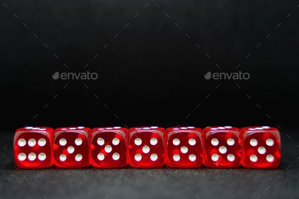 Close up of a line of red dice isolated on a black background Stock ...