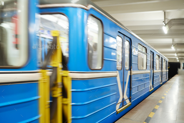 Perspective view of long blue subway train moving along platform Stock ...