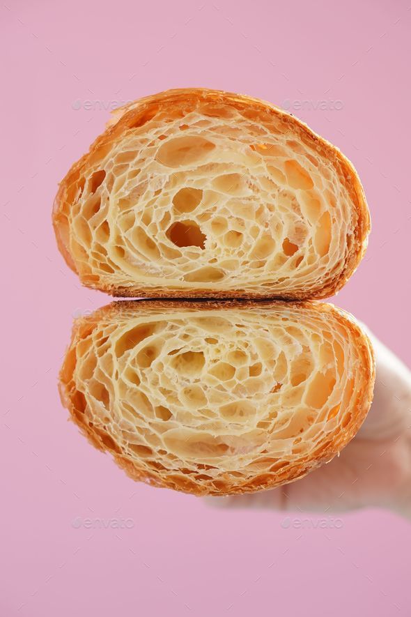 Holds freshly baked cut croissant on bright colorful background Stock ...