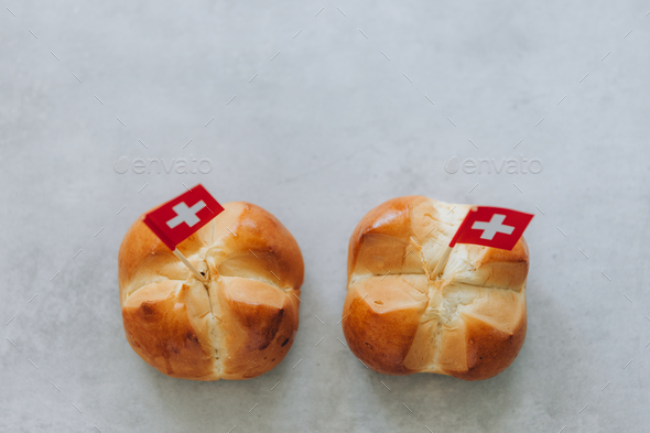 Two buns with cross shape and swiss flags. Swiss national bread Stock ...